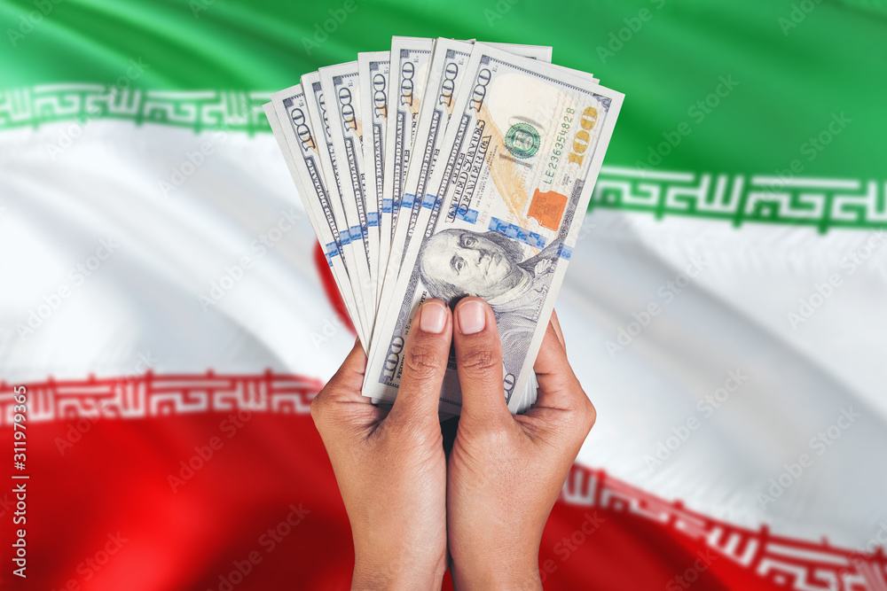 Iran financial concept. Female hand holding dollar banknotes on ...
