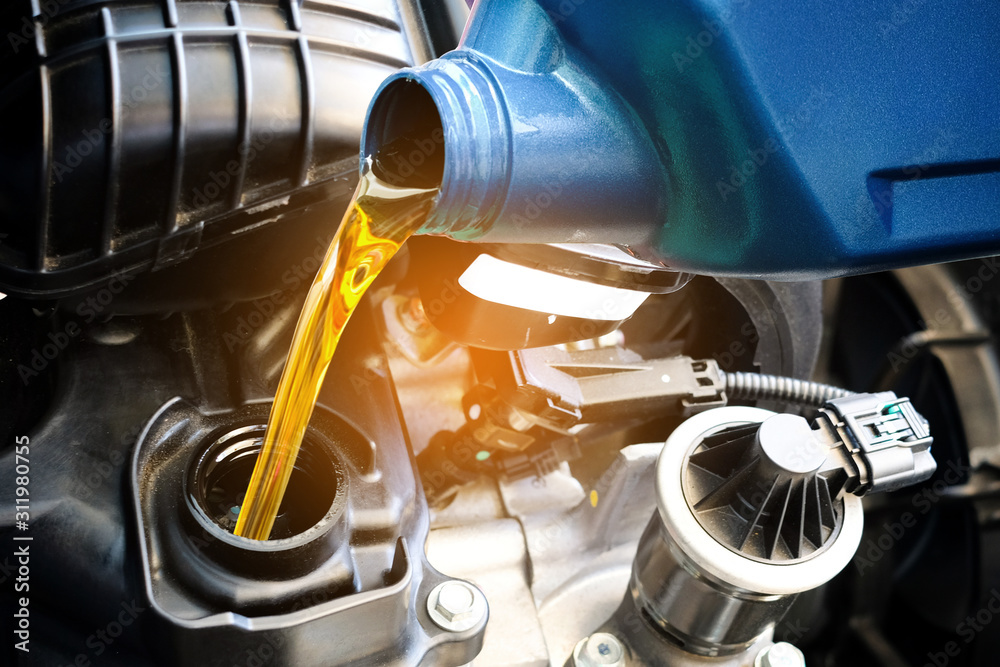 Refueling and pouring oil quality into the engine motor car ...