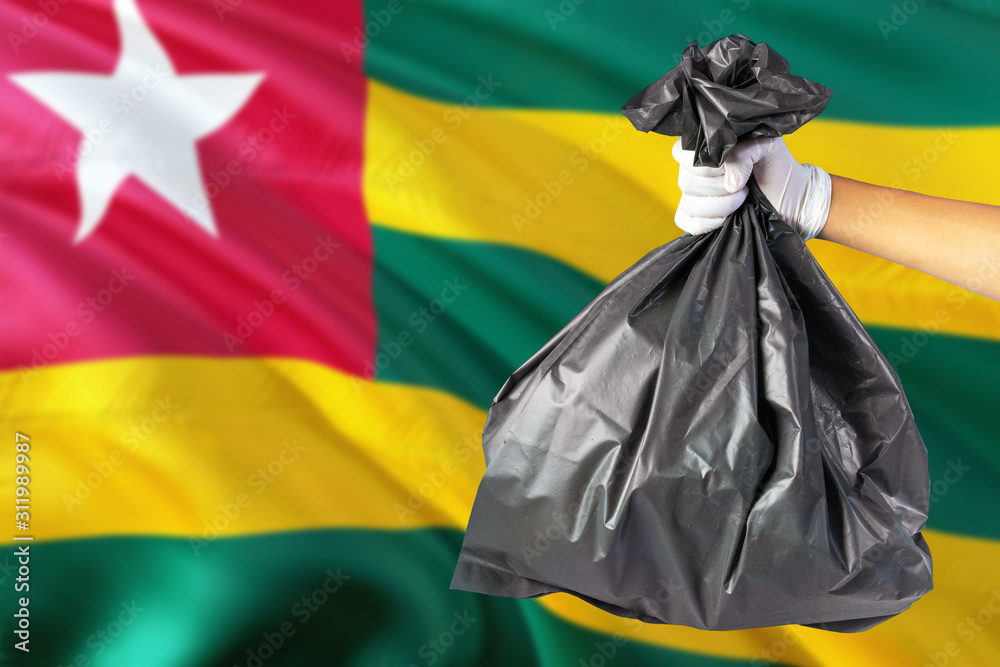 Togo environmental protection concept. The male hand holding a garbage ...
