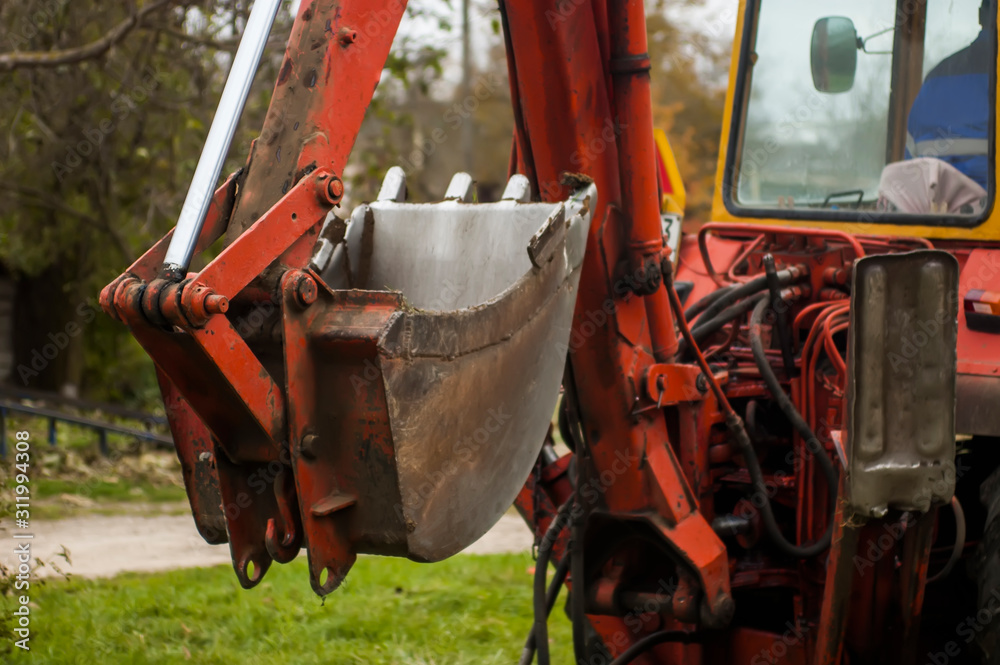 Worker driving a vintage backhoe loader (bulldozer, bull dozer ...