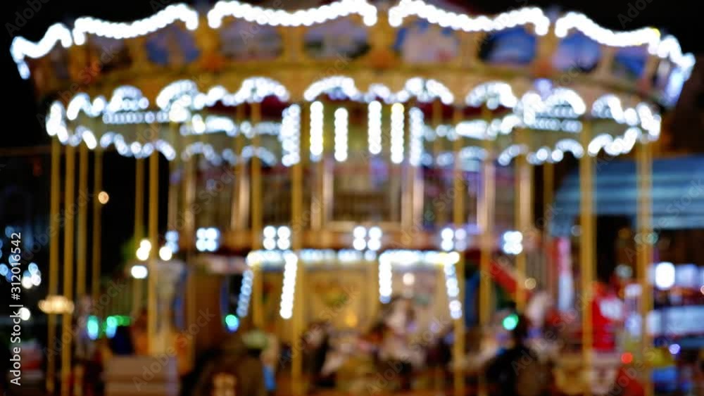 Christmas carousel blurred video. Bright carousel with lights and ...