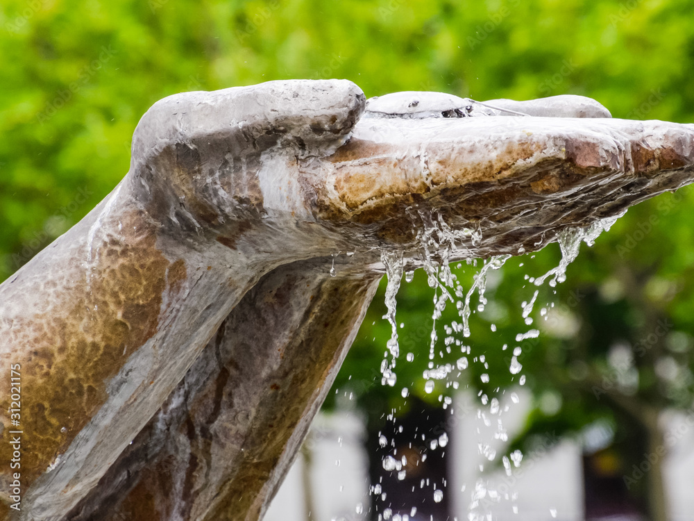 Hands statue from which water flows. Monument decoration on the Photos ...