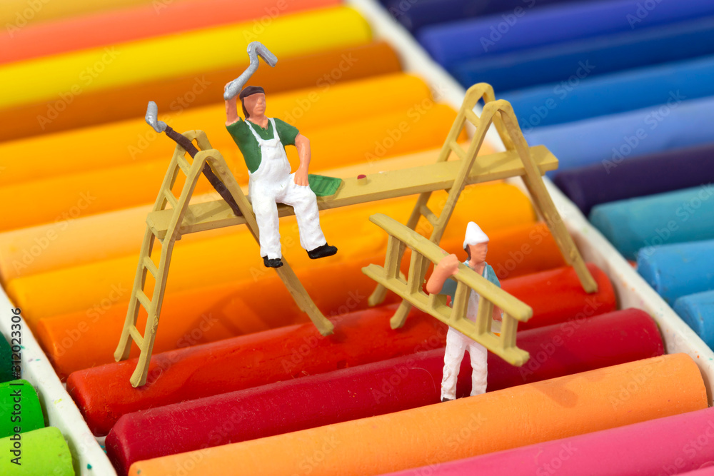 Miniature scale model painters and decorators with ladders on a set of ...