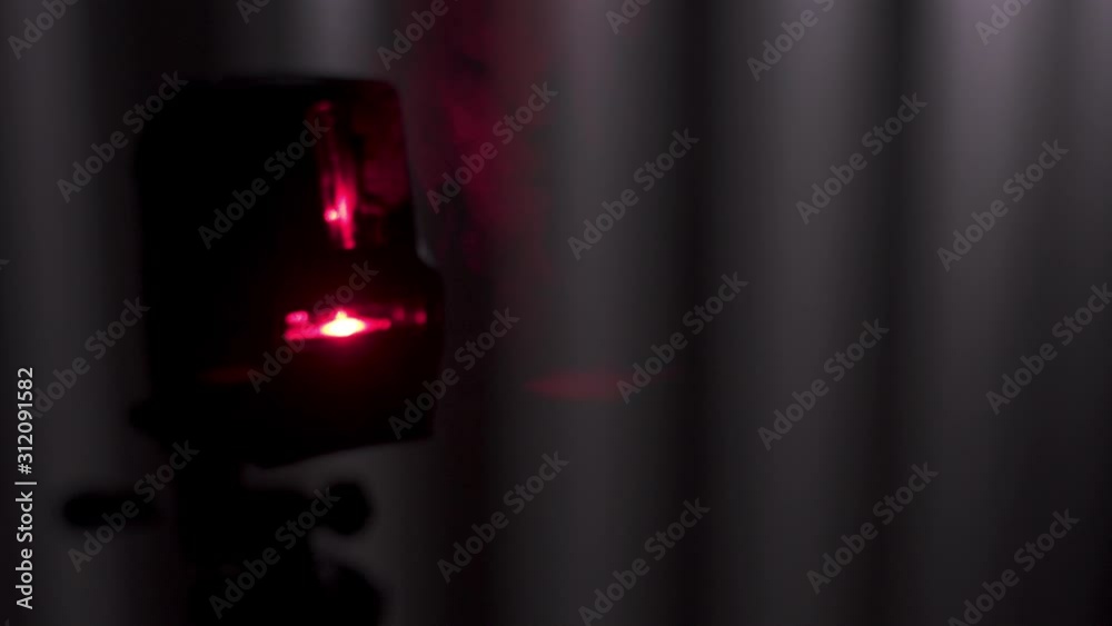Red laser light lines for level measure in dark room, construction ...