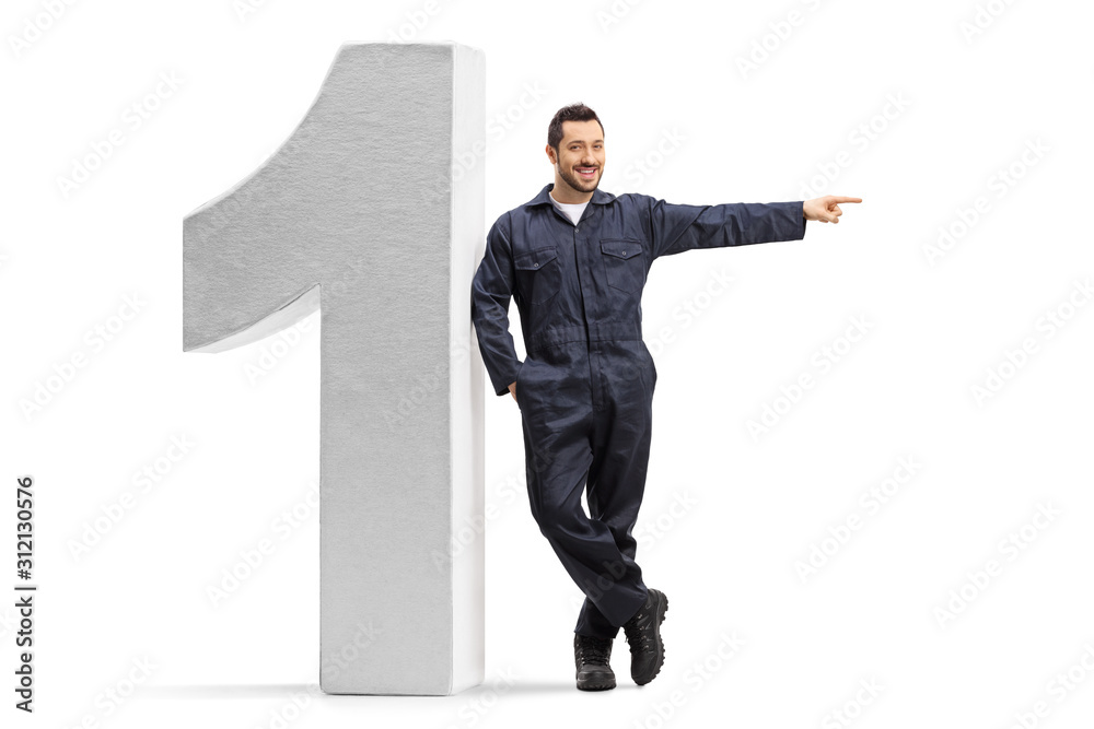 Male worker in an overall uniform leaning on a big number one and ...