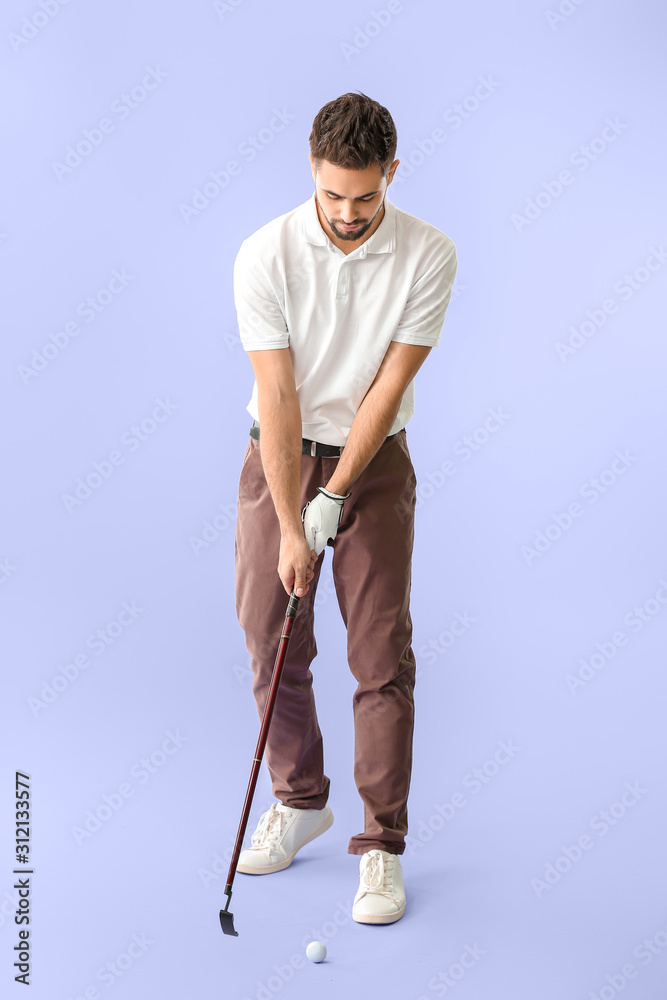 Handsome male golfer on color background Stock Photo | Adobe Stock