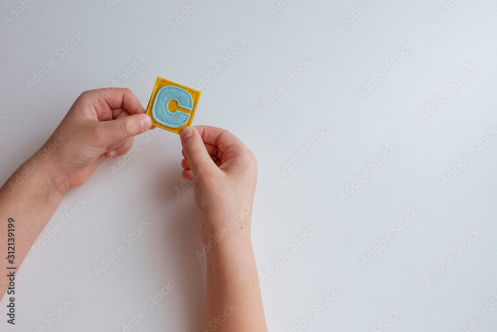 Alphabet. Letter C. Hands of the child hold letters. Learn ABC alphabet ...