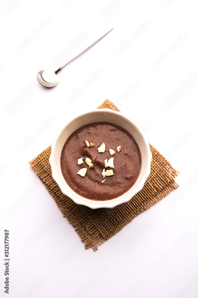 Sweet Ragi Malt / Healthy Ragi Porridge in a bowl garnished with ...