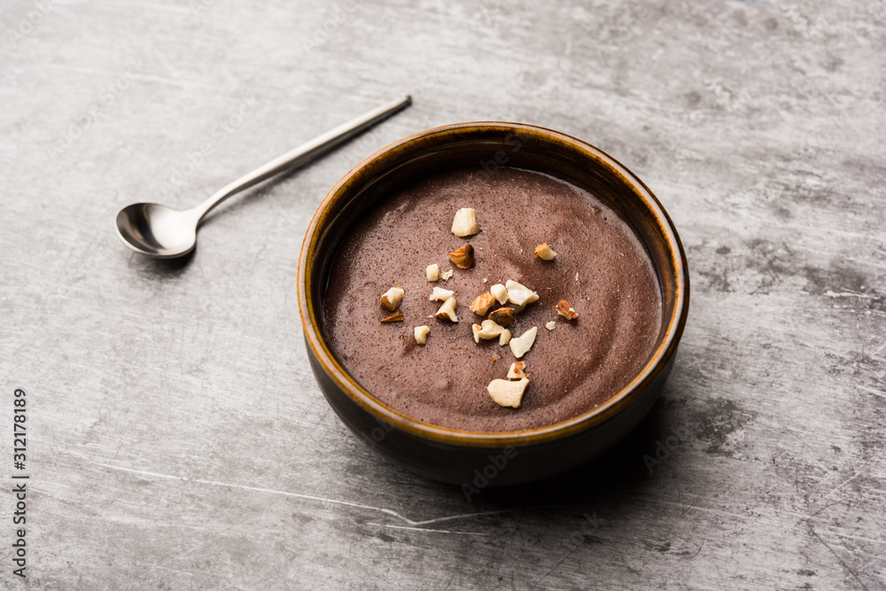 Sweet Ragi Malt / Healthy Ragi Porridge in a bowl garnished with ...