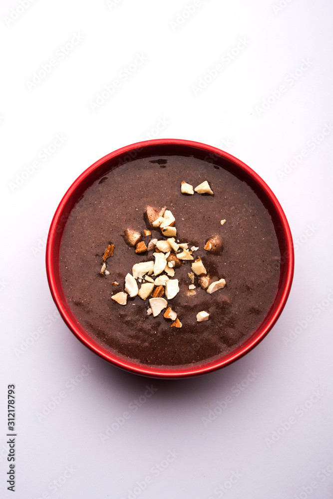 Sweet Ragi Malt / Healthy Ragi Porridge in a bowl garnished with ...