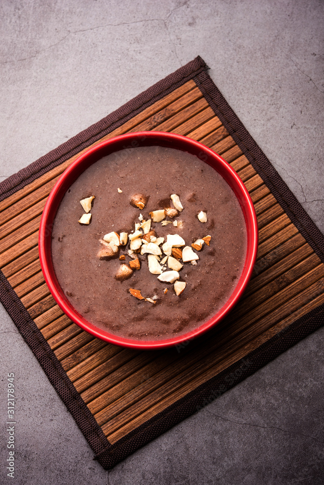 Sweet Ragi Malt / Healthy Ragi Porridge in a bowl garnished with ...