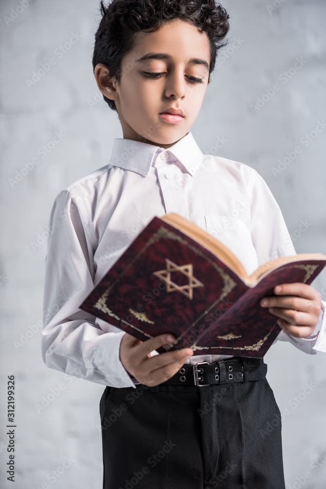 cute jewish boy in white shirt reading tanakh Stock Photo | Adobe Stock