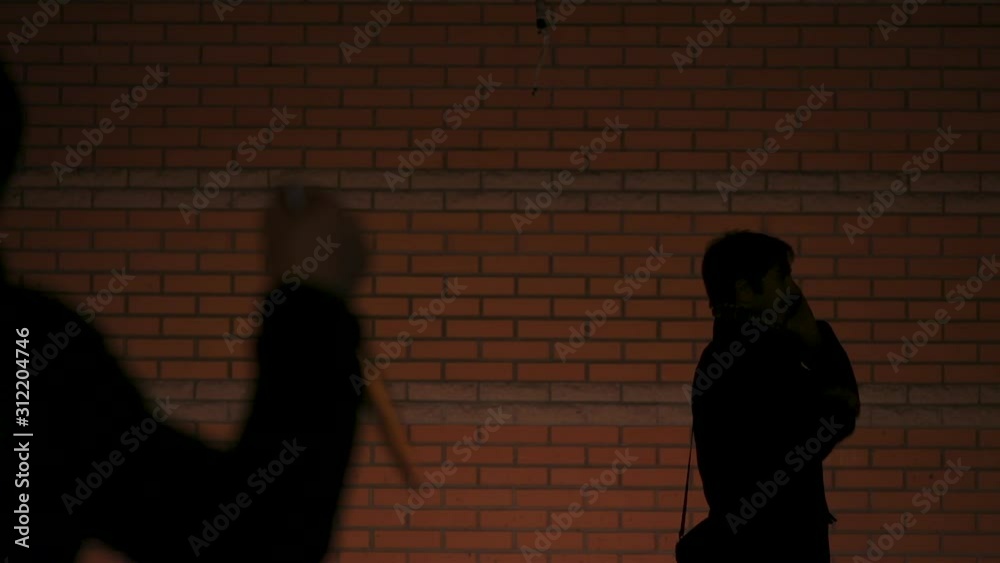 Serial killer with a kitchen knife attacks and swungs upwards blade ...