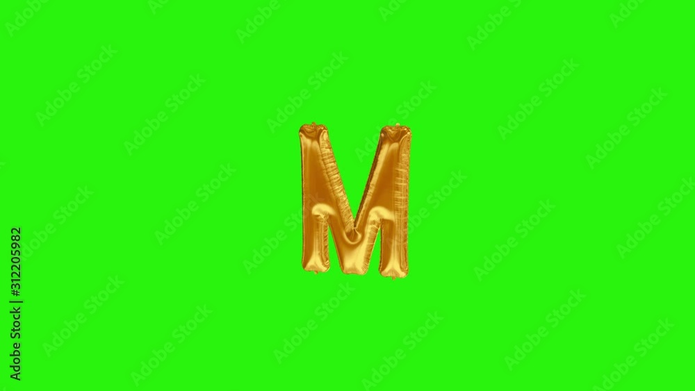 Golden letter M. Gold foil helium balloon alphabet floating on green ...