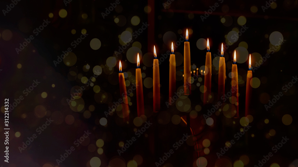 Menorah with lit candles in celebration of Chanukah. A symbolic candle ...