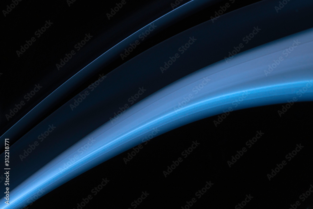 A close up macro photo of a diagonal wisp of blue smoke on a black ...