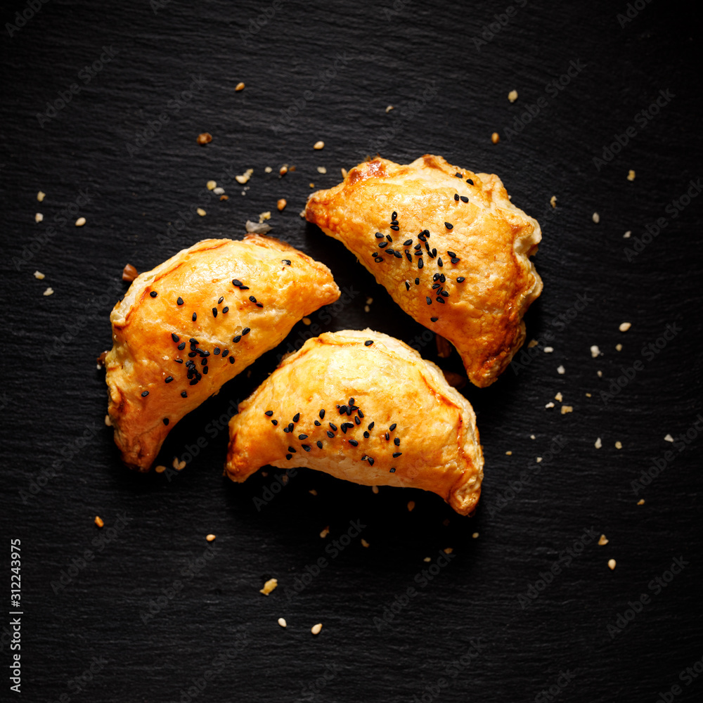 Puff pastry with mushroom filling sprinkled with nigella seeds on a ...