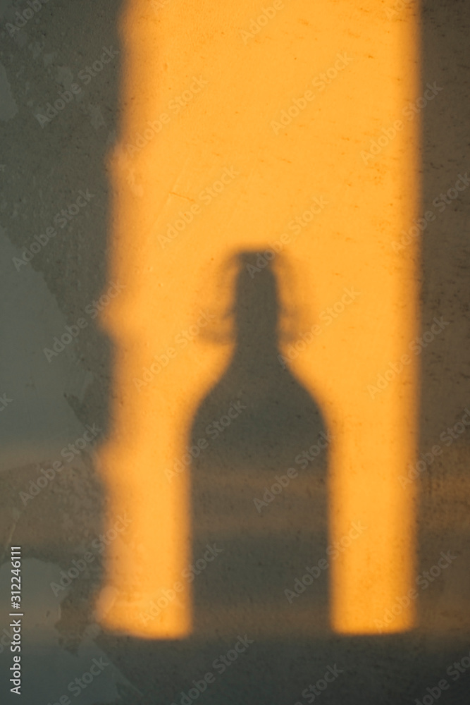 Shadow of glass water bottle at concrete wall texture background. Stock ...