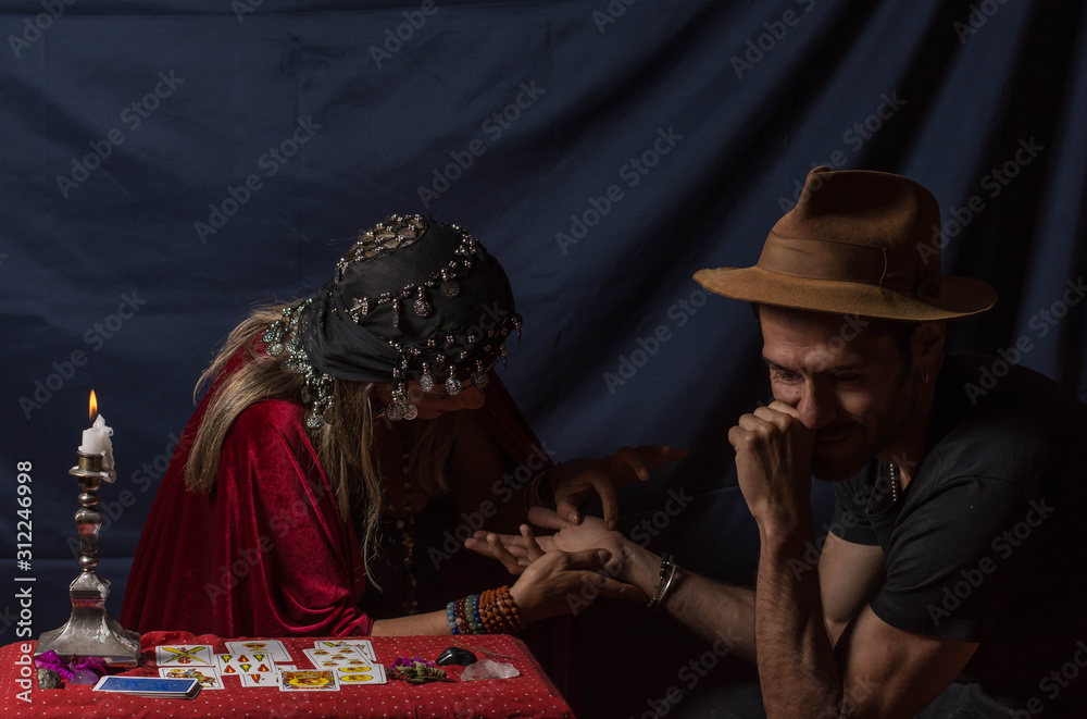 Gypsy fortuneteller or esoteric Oracle reading hand lines in a young ...