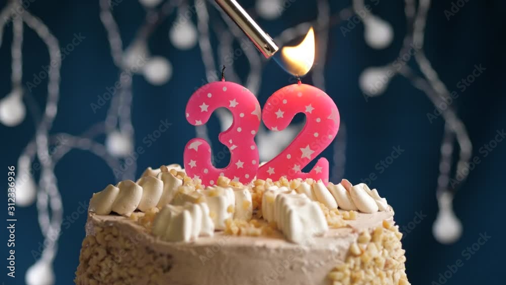 Birthday cake with 32 number pink candle on blue backgraund. Candles ...