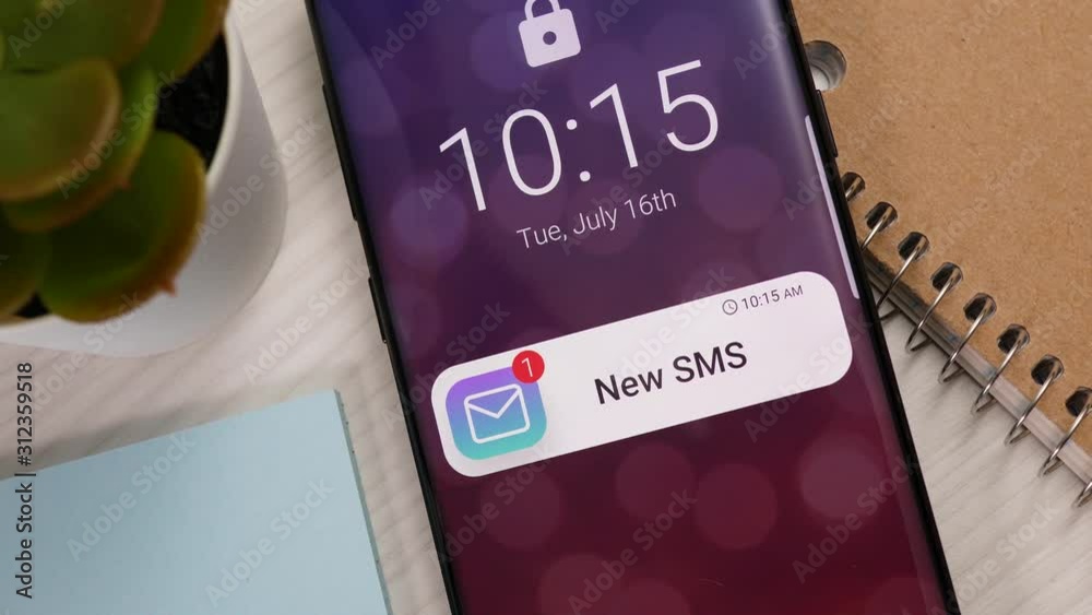 Smartphone showing a new message notification banner appearing on the ...
