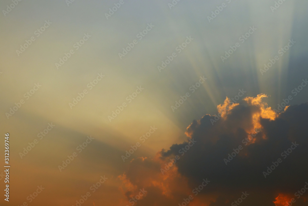 Blue sky with rays of light coming out through clouds. Dramatic sunbeam ...