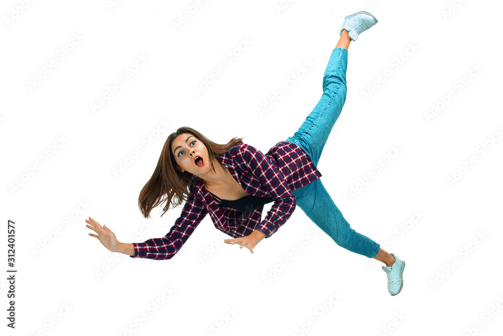 A second before falling. Caucasian young girl falling down in moment ...