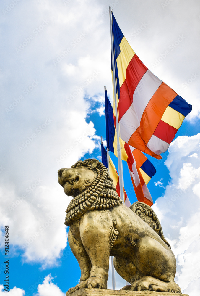 Brave Lion Posture sitting Statue in Gold with Buddhist flags in ...