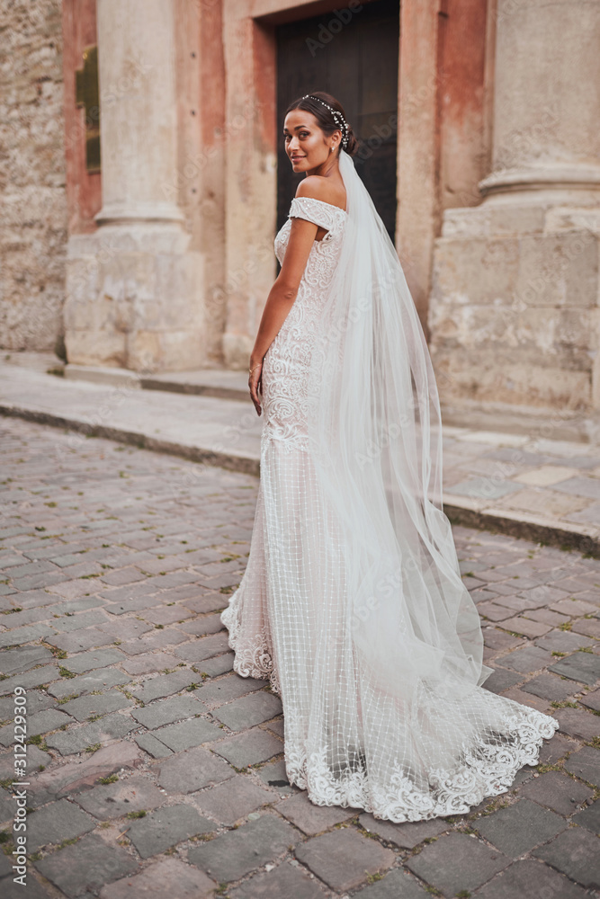 Beautiful young bride on a walk in wedding dress Stock Photo | Adobe Stock
