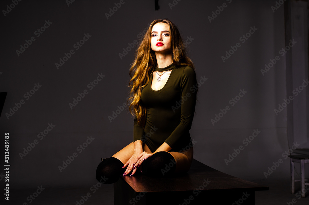 Beautiful dancer. Girl model. the girl sits in a hat and sits on a ...