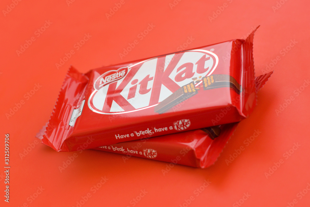 Kit Kat chocolate bar in red wrapping lies on red background. Kit kat ...