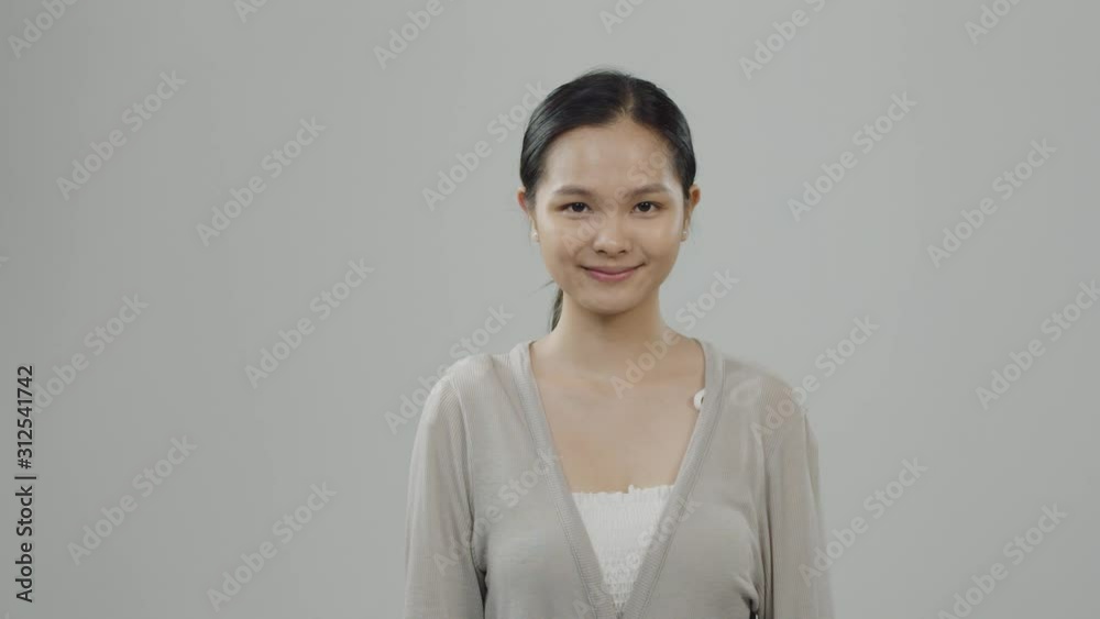 Young, attractive Asian woman smiles at a advertising casting audition ...