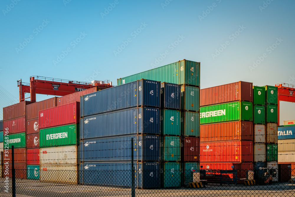 Cranes loading shipping container on freight harbour logistics centre ...