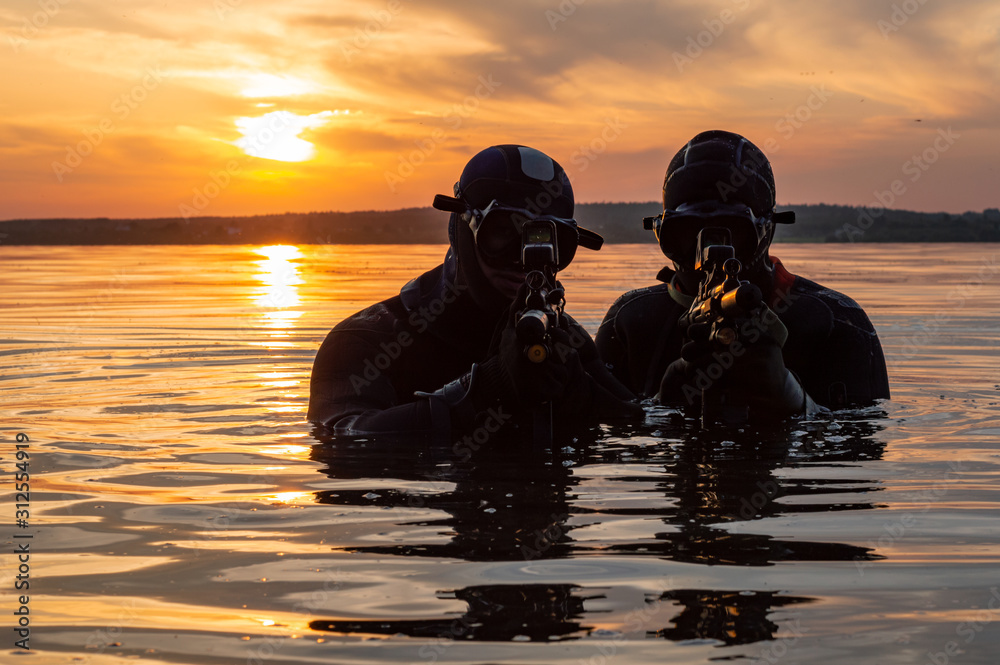 Team of fighters of a special unit move on water to complete the task ...
