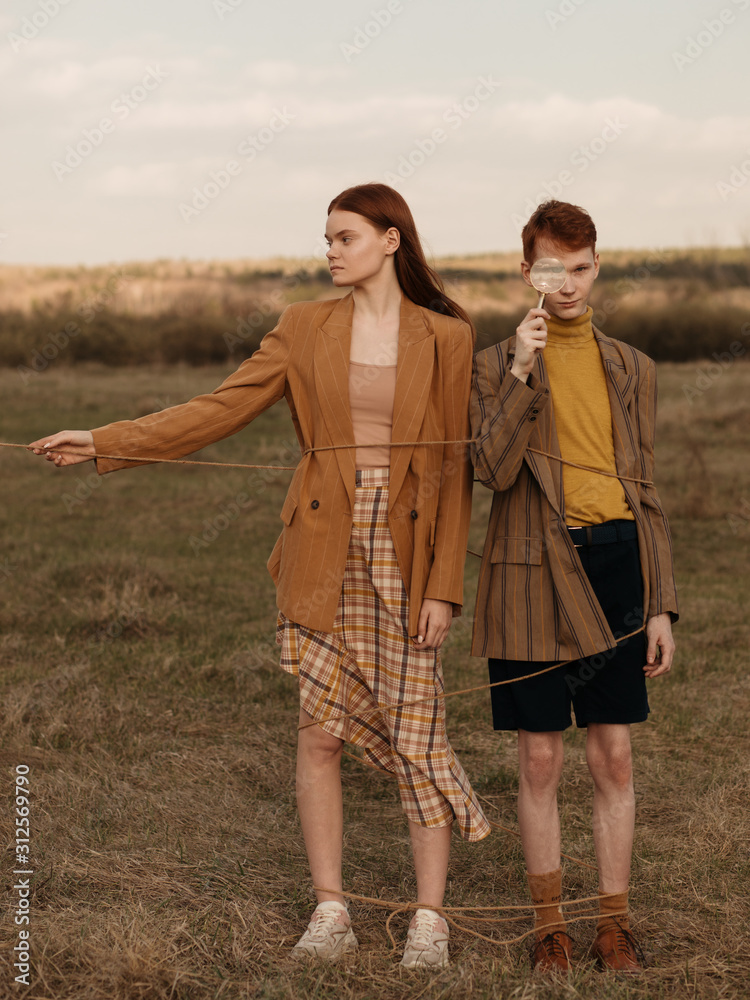 Twins tied up with rope in field Stock Photo | Adobe Stock