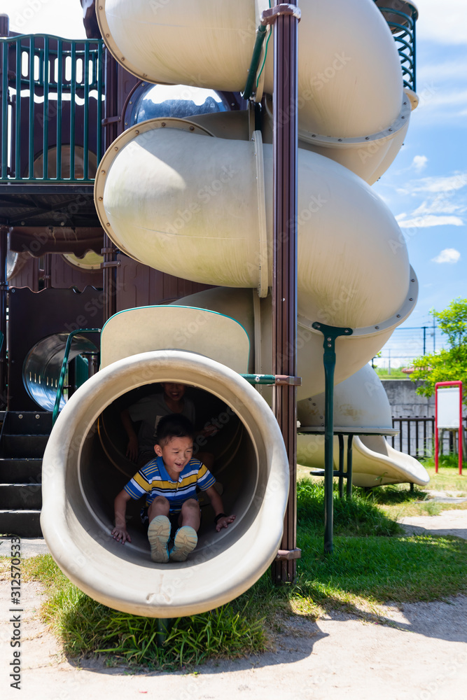 Children playing slides at the playground Stock Photo | Adobe Stock