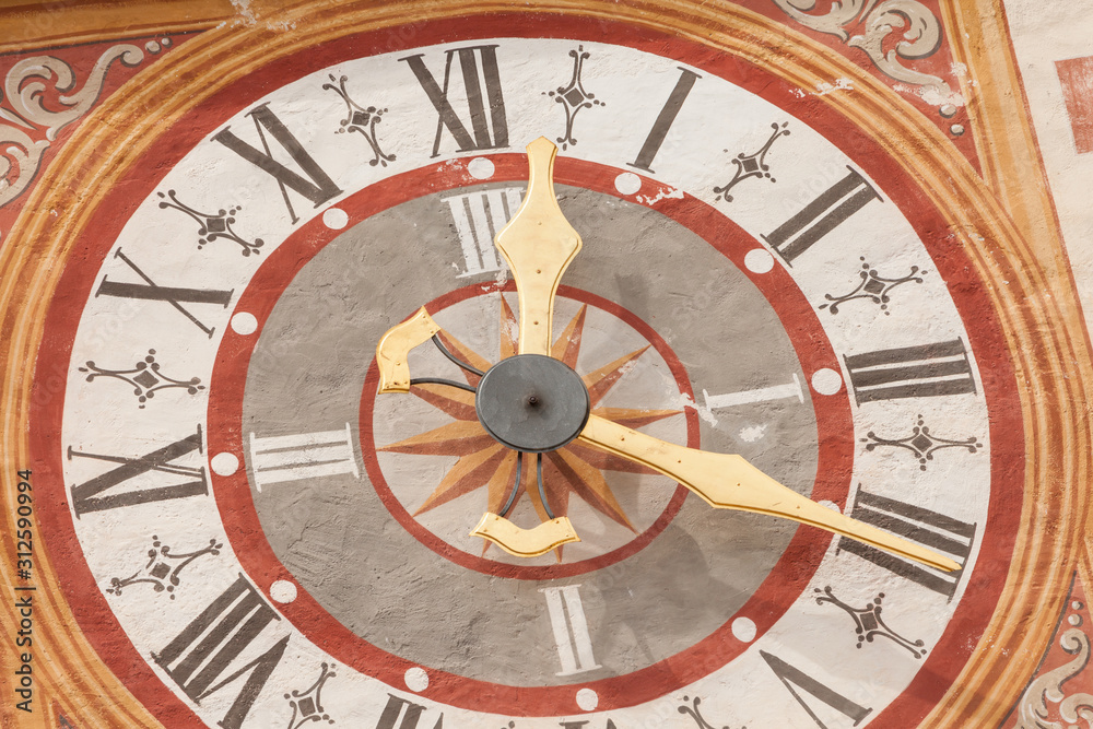 A detail of the clock painted on the bell tower of the St. Cristina ...
