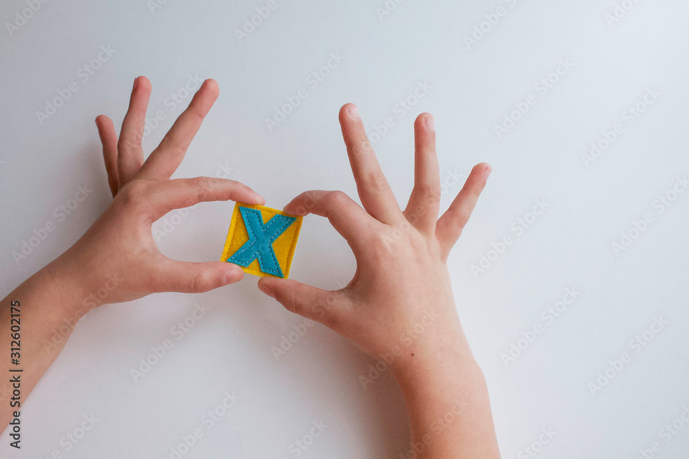 Alphabet. Letter X. Hands of the child hold letters. Learn ABC alphabet ...