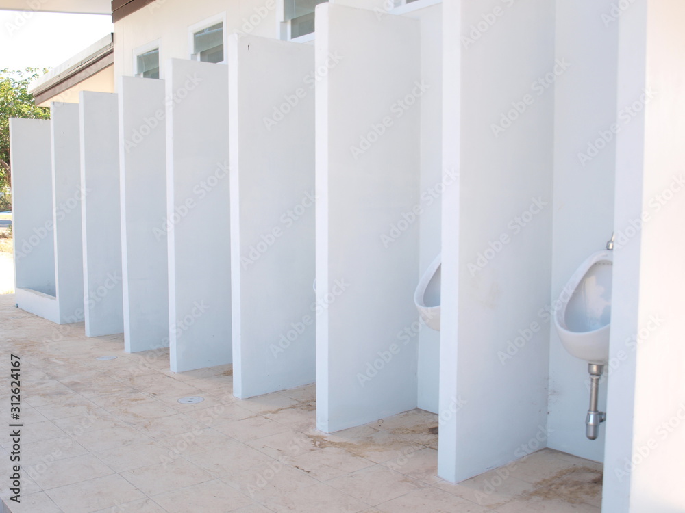Row of outdoor men urinals with a walled partition for public toilets ...