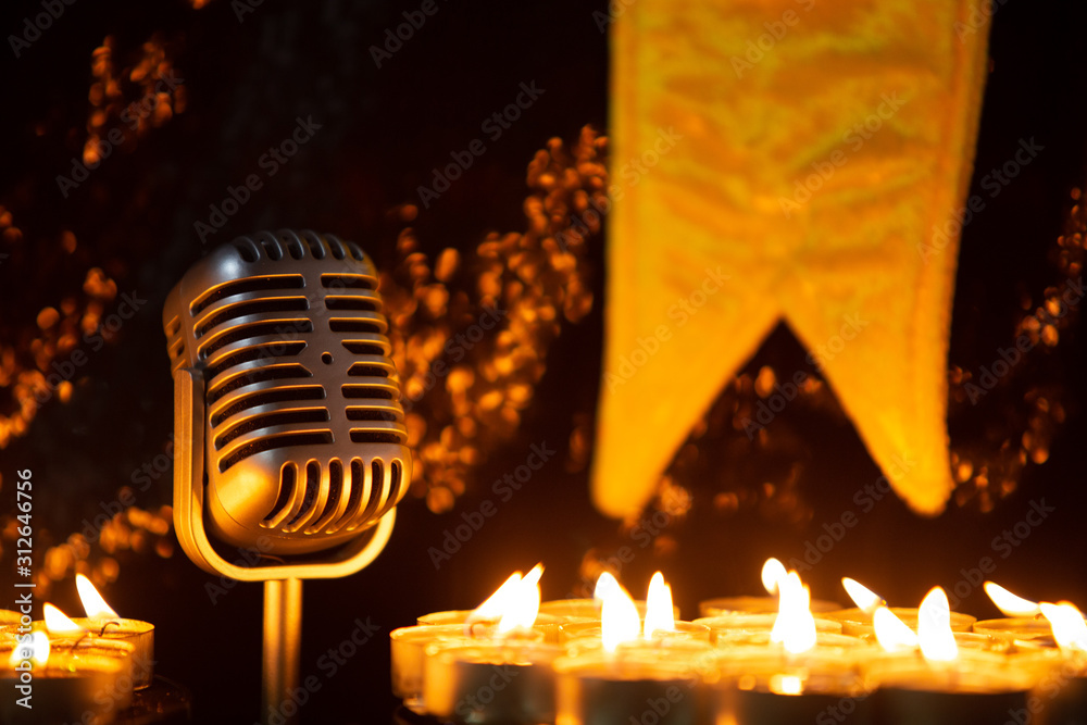 Retro Microphone with row many tealight candles show with Yellow Sash ...