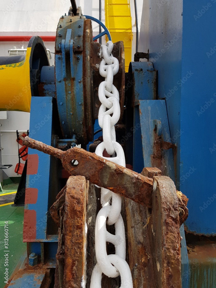 White painted anchor windlass chain on a anchor handling tug boat Stock ...