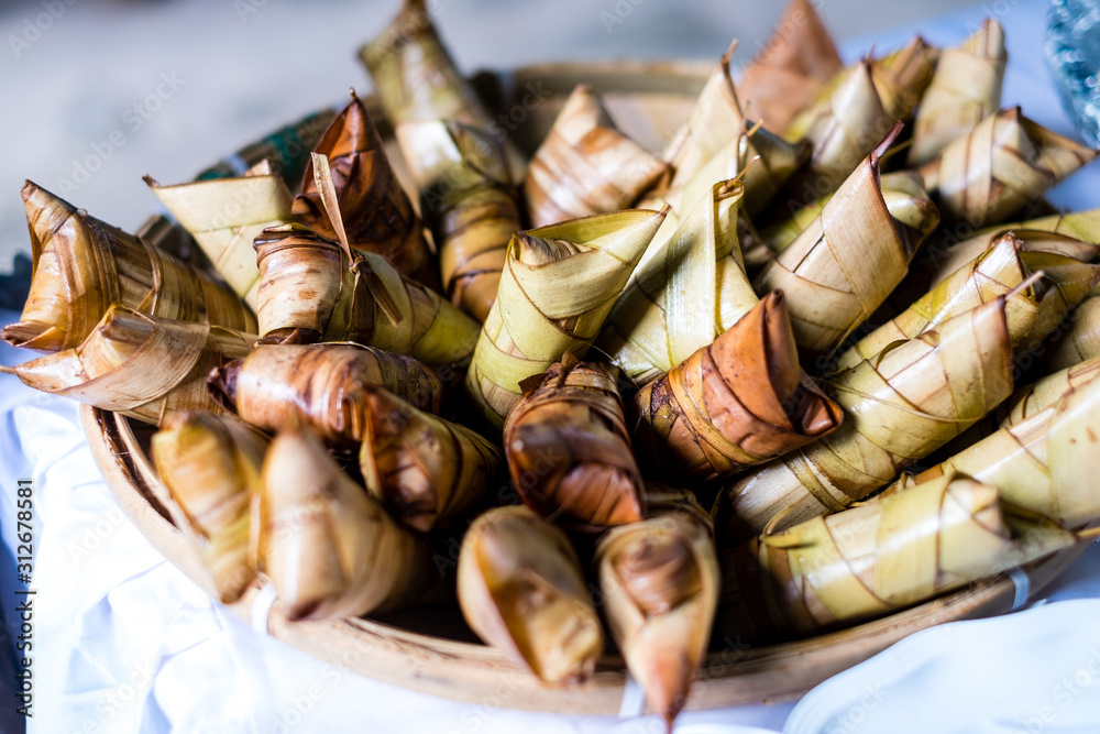 A bunch of sticky rice logs AKA "ibus" or "ibos" wrapped in young ...