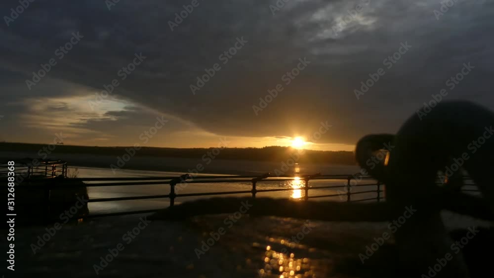 Waterfront canal gates sunrise across river Mersey. Close up bokeh ...