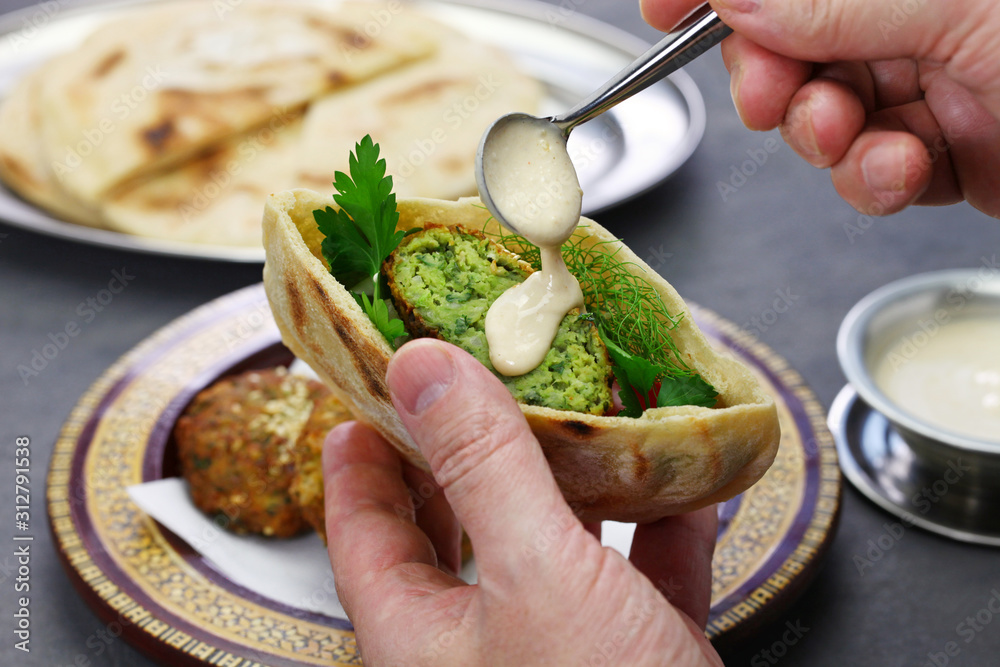 egyptian falafel served in a pita bread with tahini sauce Stock Photo ...