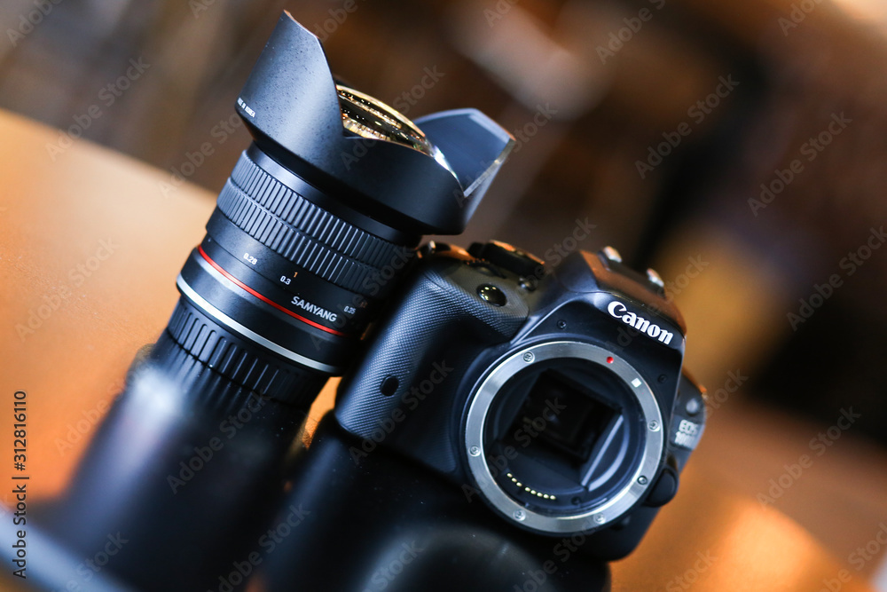 Professional Canon DSLR camera with Samyang ultrawide lens on a table ...