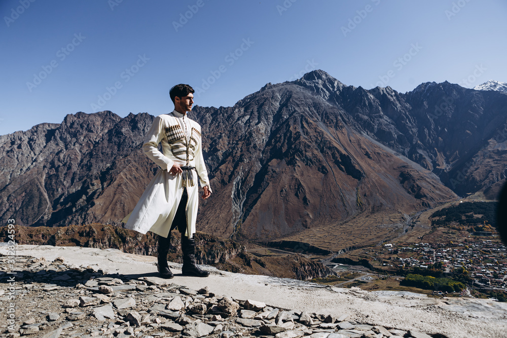 noise effect, selective focus: stylish Georgian man dressed in white ...