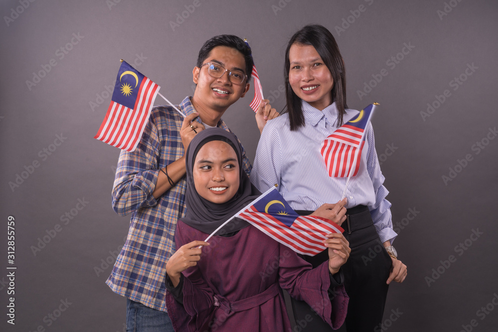 Happy multi racial Malaysian people holding Malaysia Flag.Independence ...