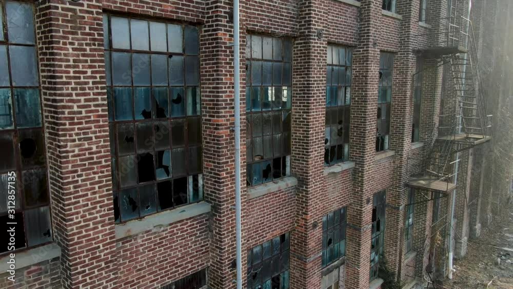 Rising aerial of rundown factory building, proposed revitalization to ...