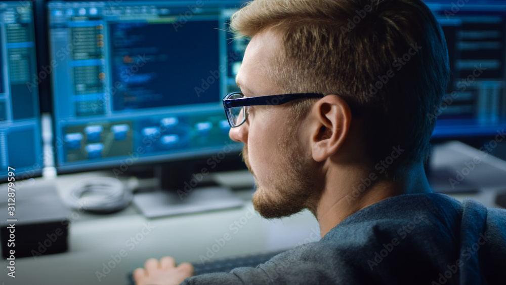 IT Specialist Works on Personal Computer with Screens Showing Software ...