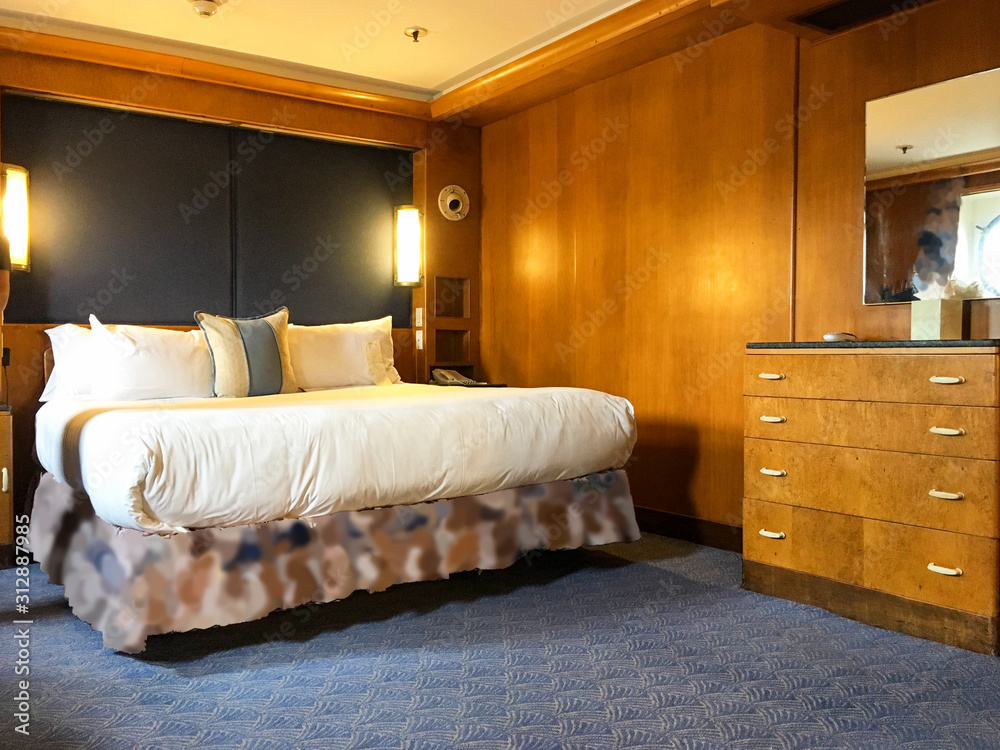 Bedroom inside luxury first class stateroom or cabin or suite with king ...